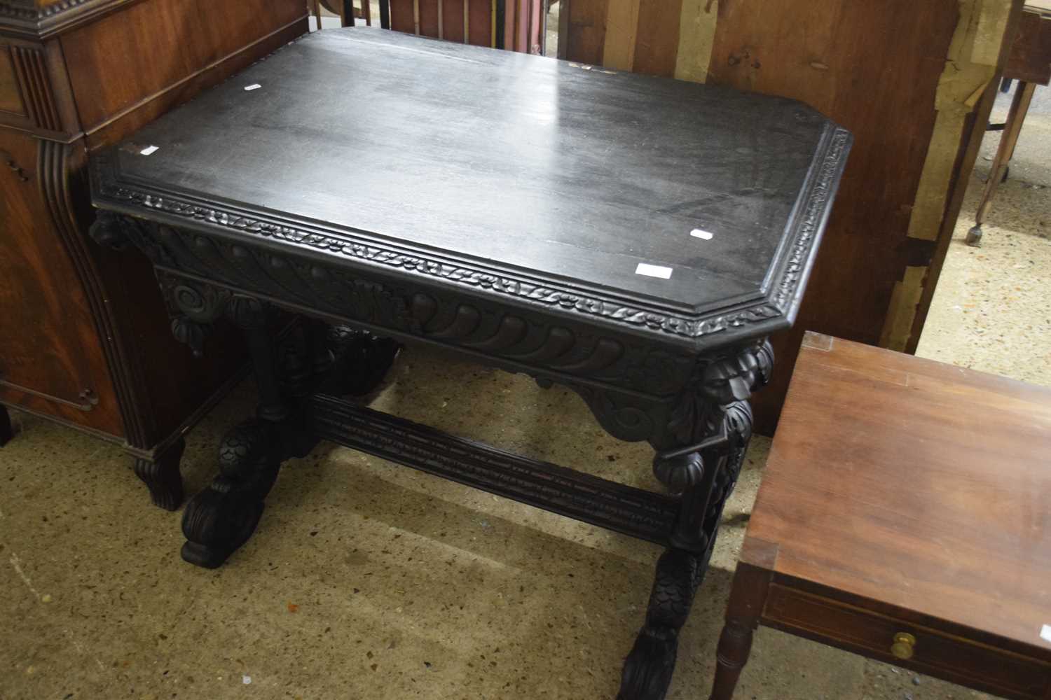 Lot 353 - A heavily carved Colonial style side table,