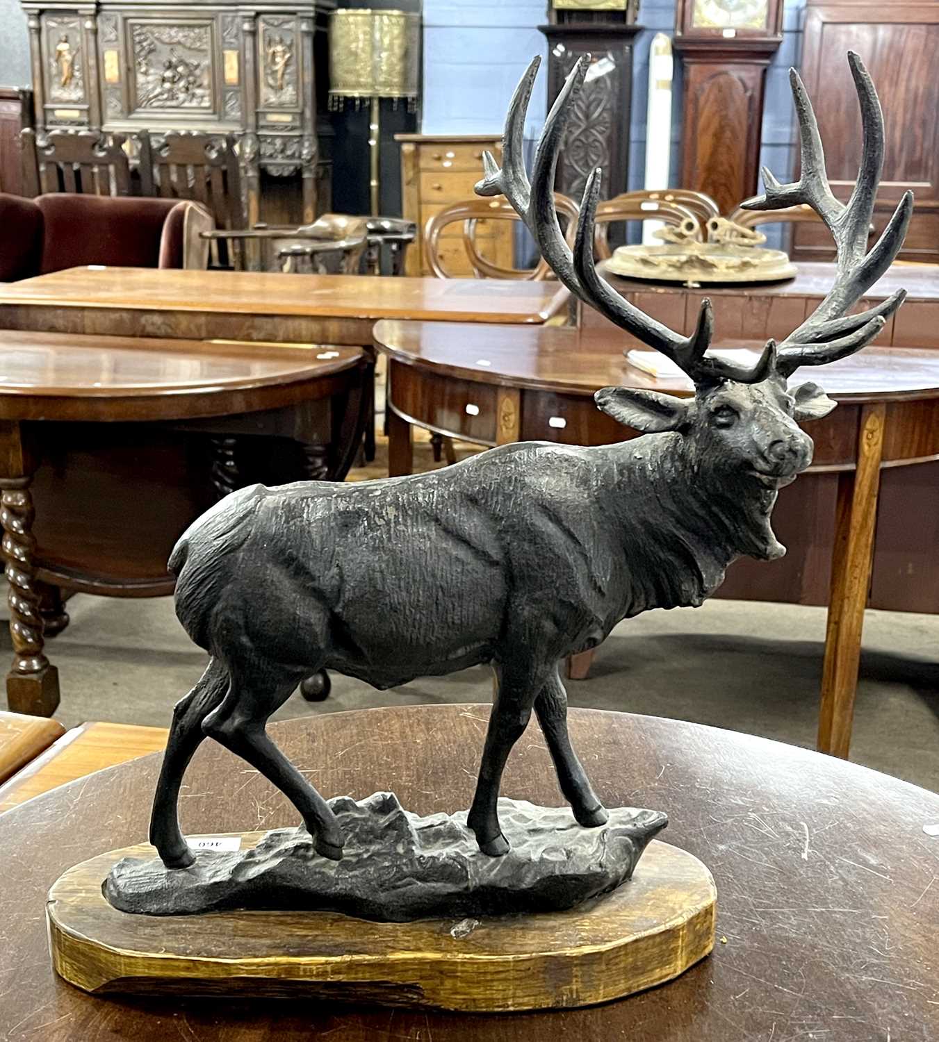 Lot 460 - A black painted iron model of a stag set on