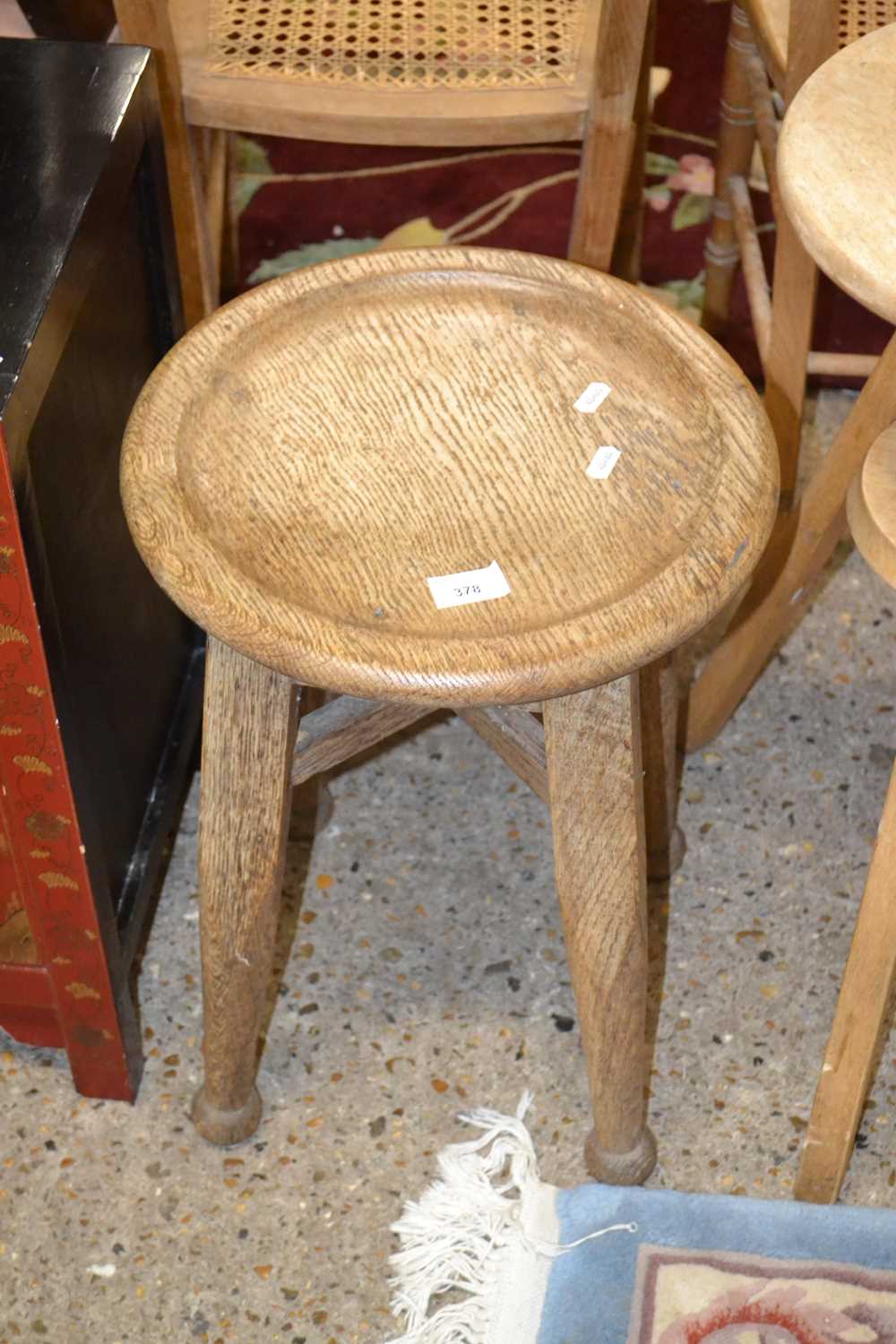 Lot 378 - An oak circular top stool on tapering legs