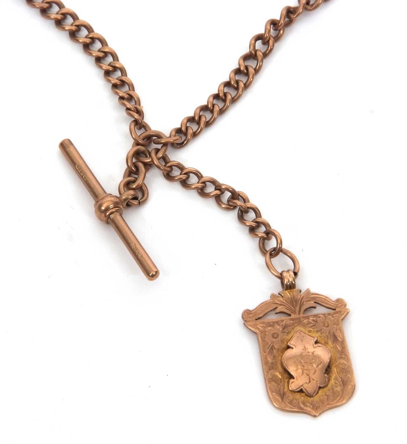 Lot 296 - A 9ct watch chain and 9ct shield shape fob,