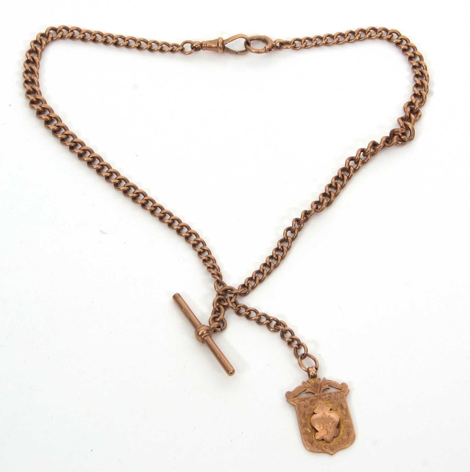 Lot 296 - A 9ct watch chain and 9ct shield shape fob,