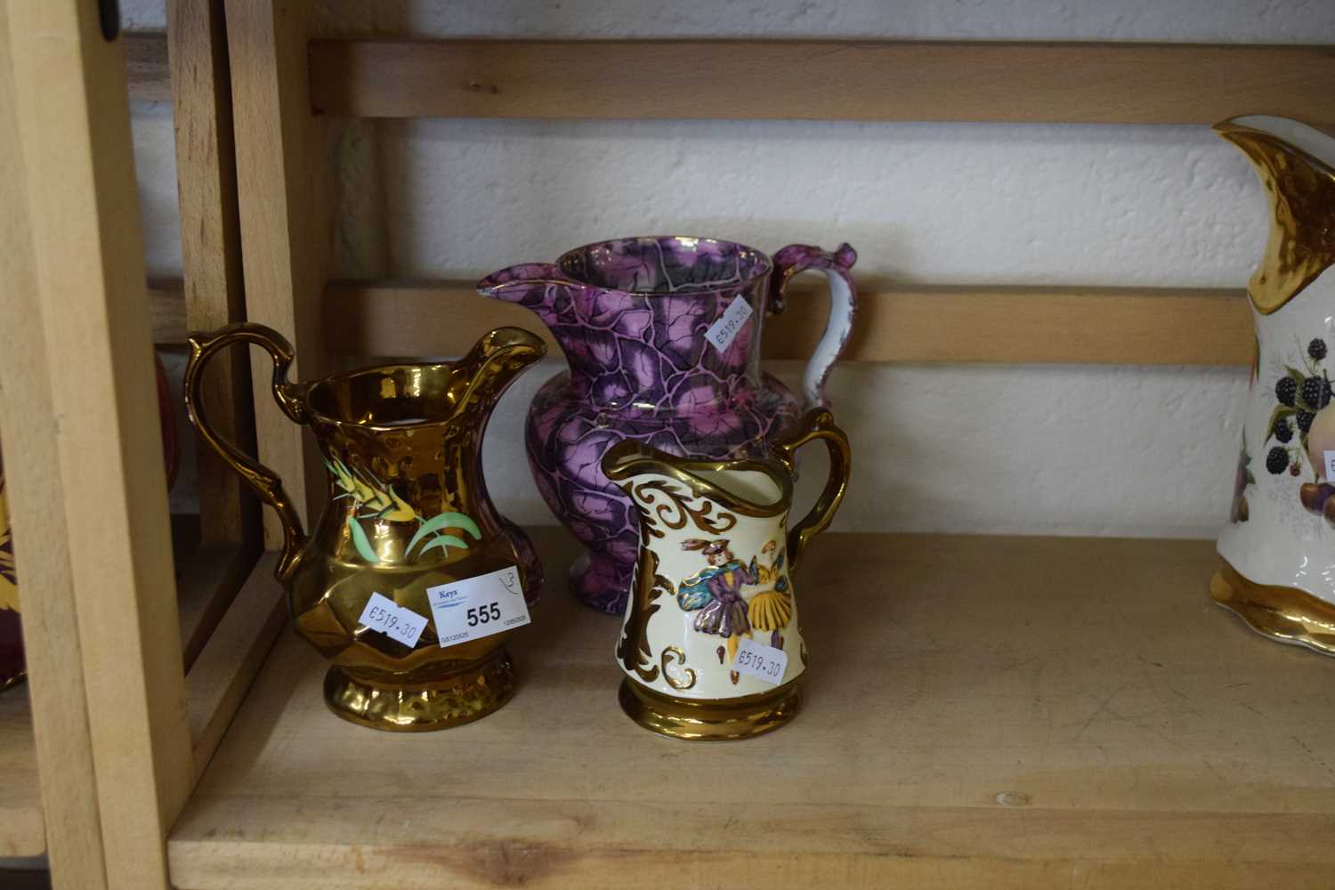 Lot 555 - Three assorted jugs, gilt painted