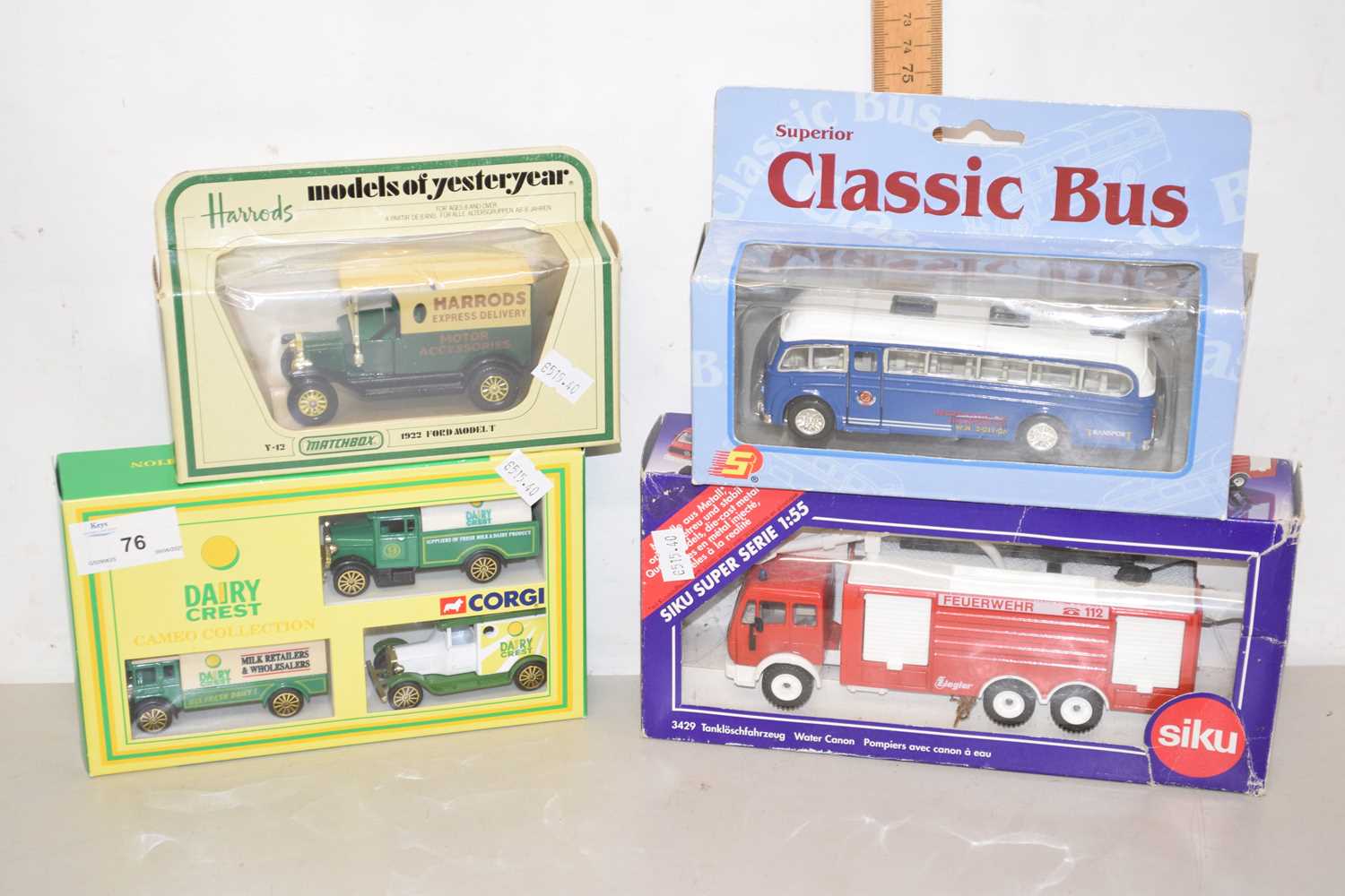 Lot 76 - A group of four various boxed toy vehicles